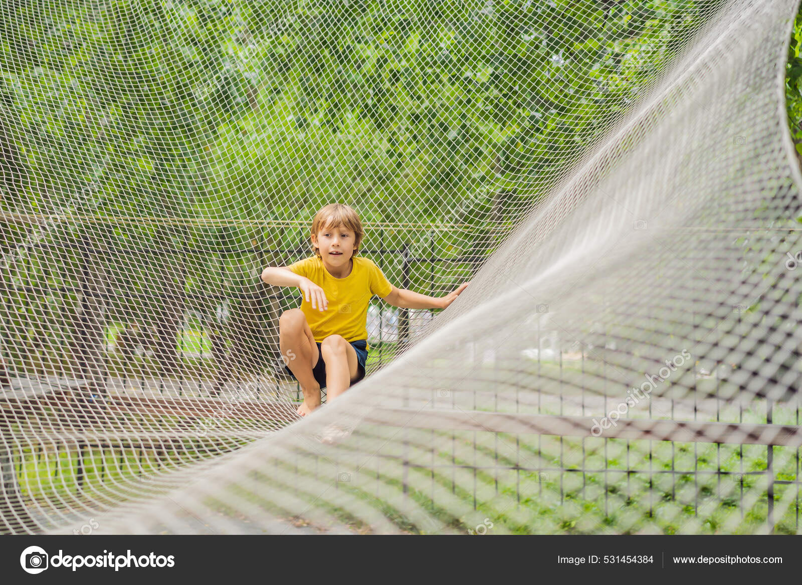Practice nets playground. boy plays in the playground shielded with a ...