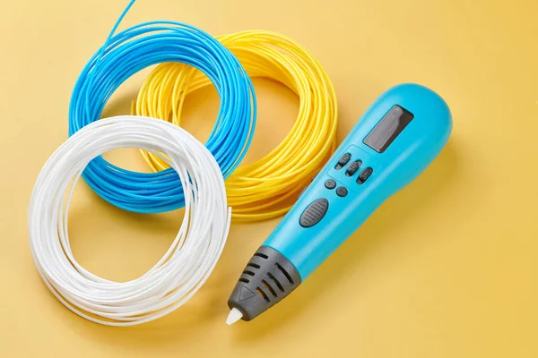 3d pen for creating volume plastic figures isolated on yellow ...