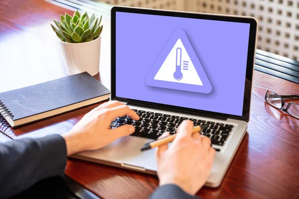 High temperature warning sign on a laptop screen. Computer overheating ...