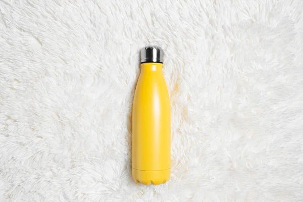 Close-up top view of eco reusable water bottle of yellow, on white ...