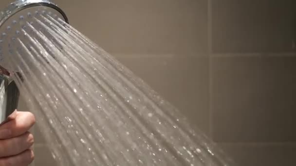 Water drops close up in the shower. bath details close-up. slow mo ...