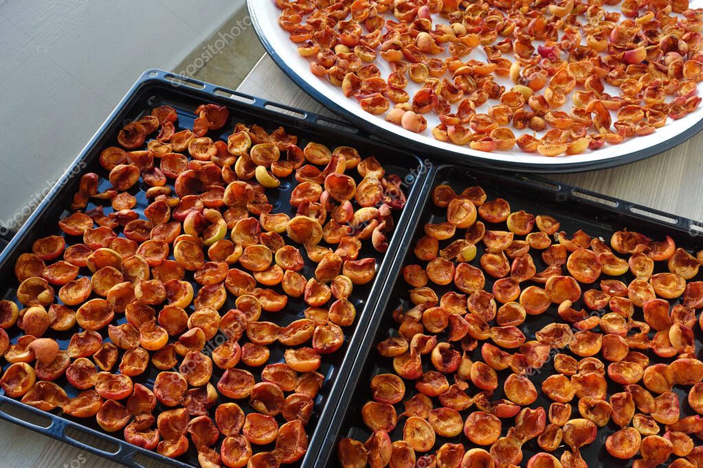 drying apricots in a metal tray on the balcony of the house, drying ...