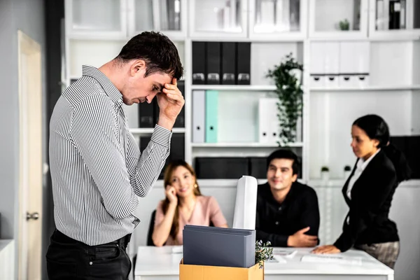 Depressed and disappointed employee packing his belongings after being ...